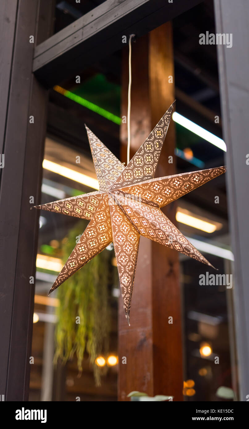 Paper stars hanging for holiday season Stock Photo - Alamy