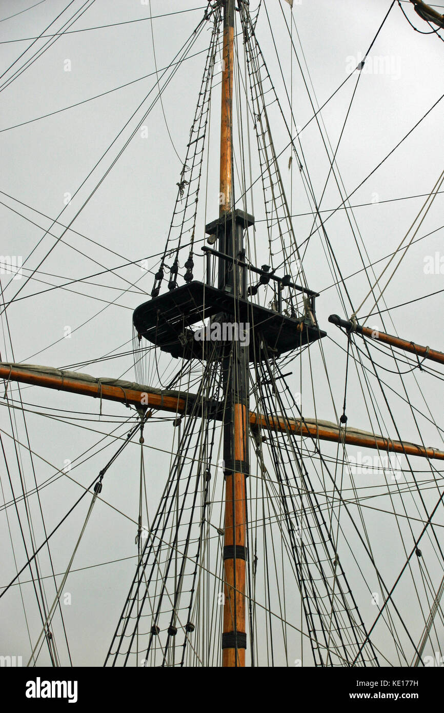 Sailing ship wooden mast and rigging with ladders and ropes with a ...