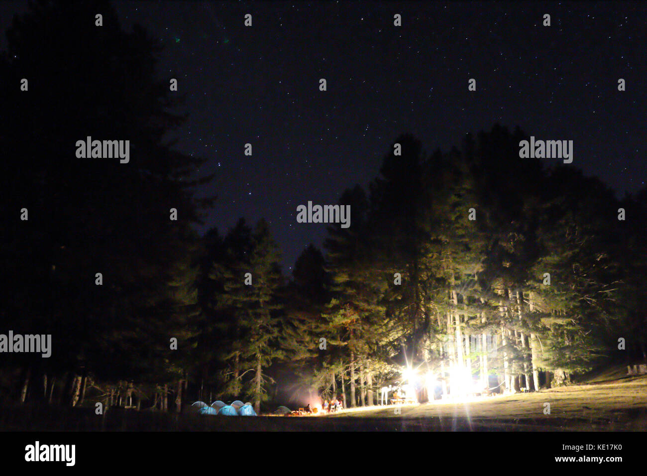Campsite at night with lights and fire, with starry sky Stock Photo - Alamy