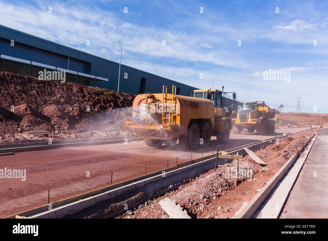 Roadworks construction preparation by industrial vehicles water ...
