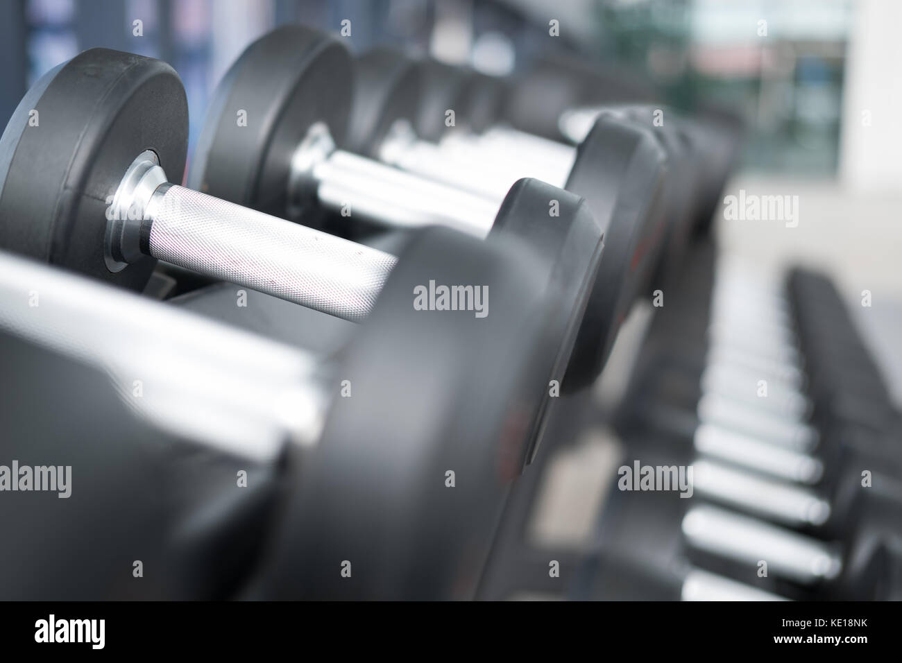 Row of dumbbells in gym. Black dumbbell set in sport fitness club ...