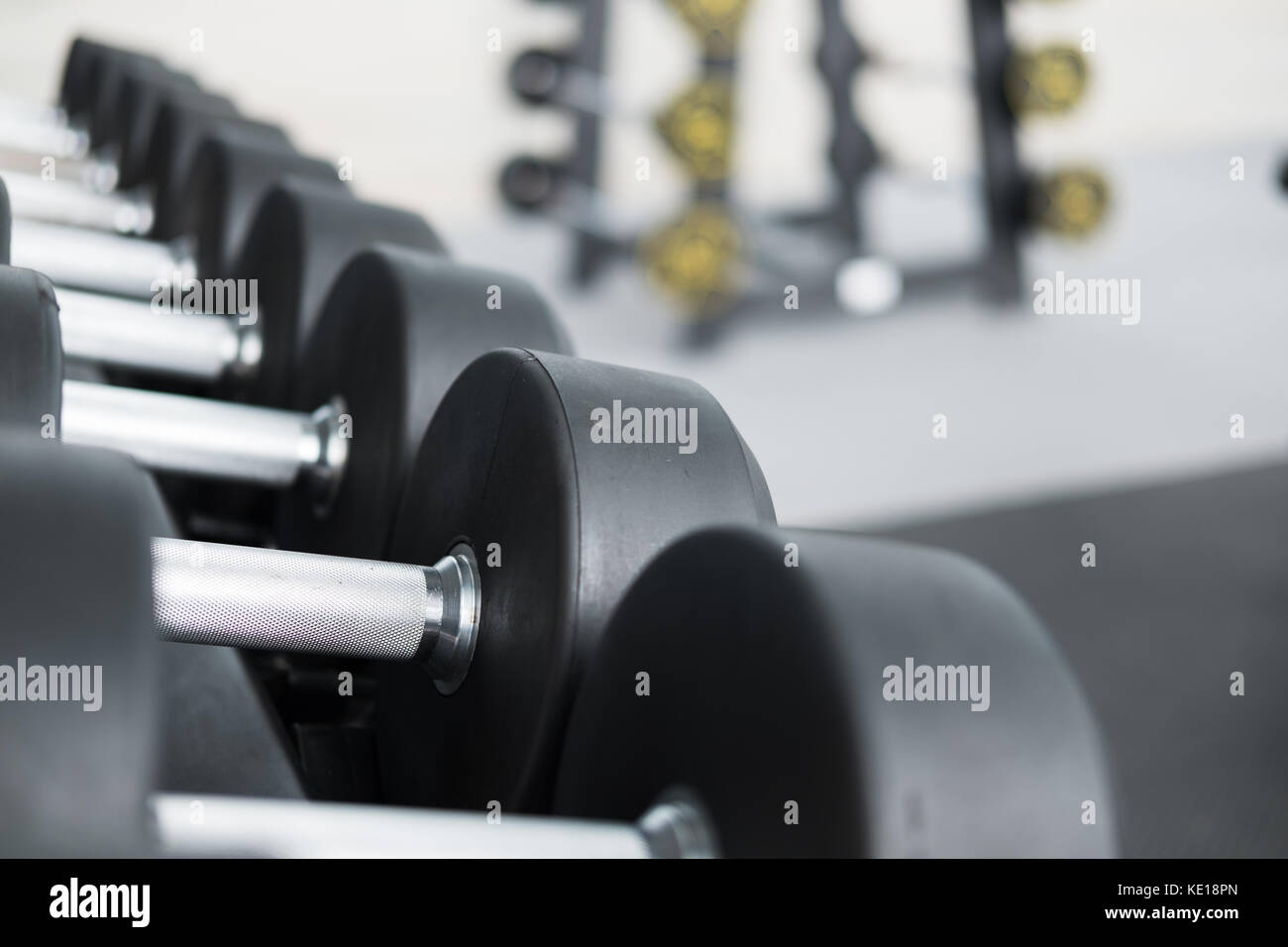 Row of dumbbells in gym. Black dumbbell set in sport fitness club ...