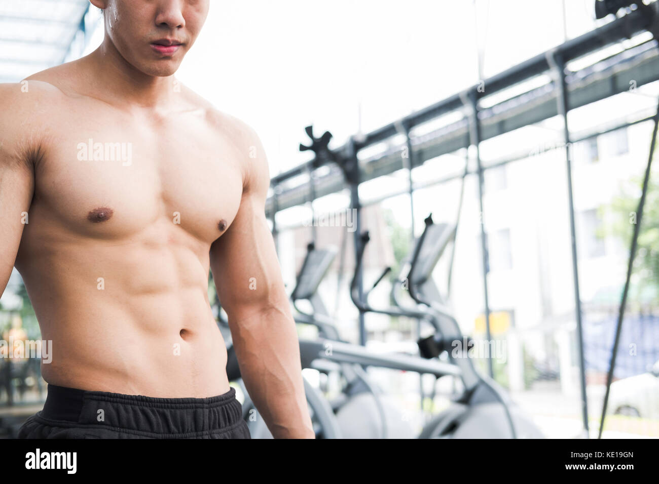 young man athlete prepare for training in gym. bodybuilder male working ...
