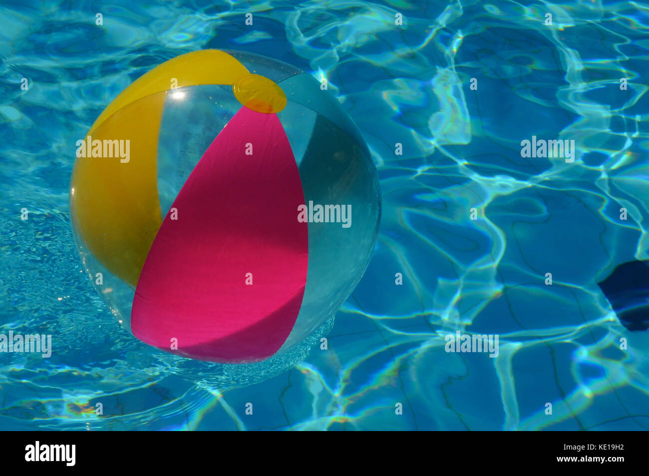 Beach ball floating in swimming pool Stock Photo - Alamy