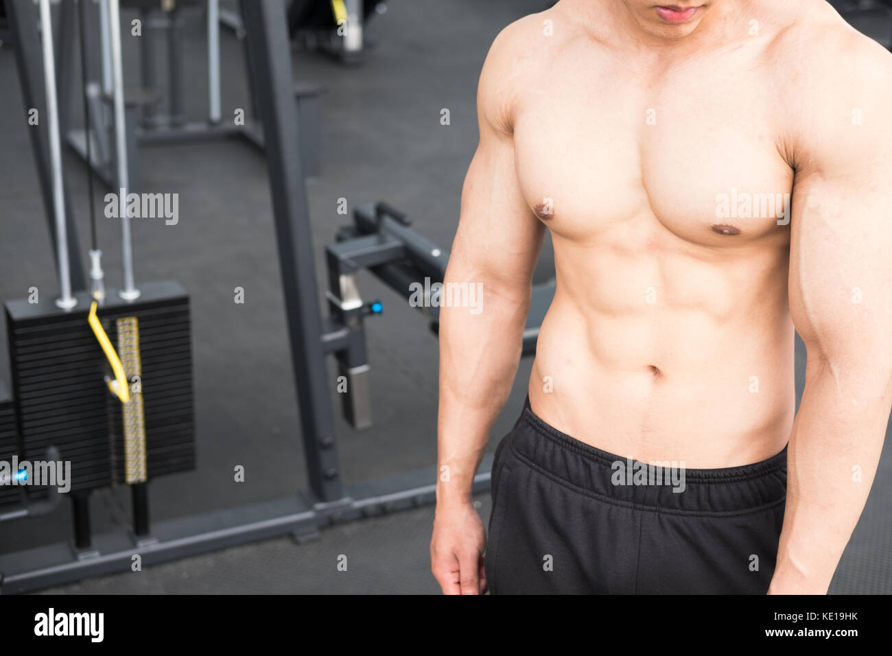 young man athlete prepare for training in gym. bodybuilder male working ...