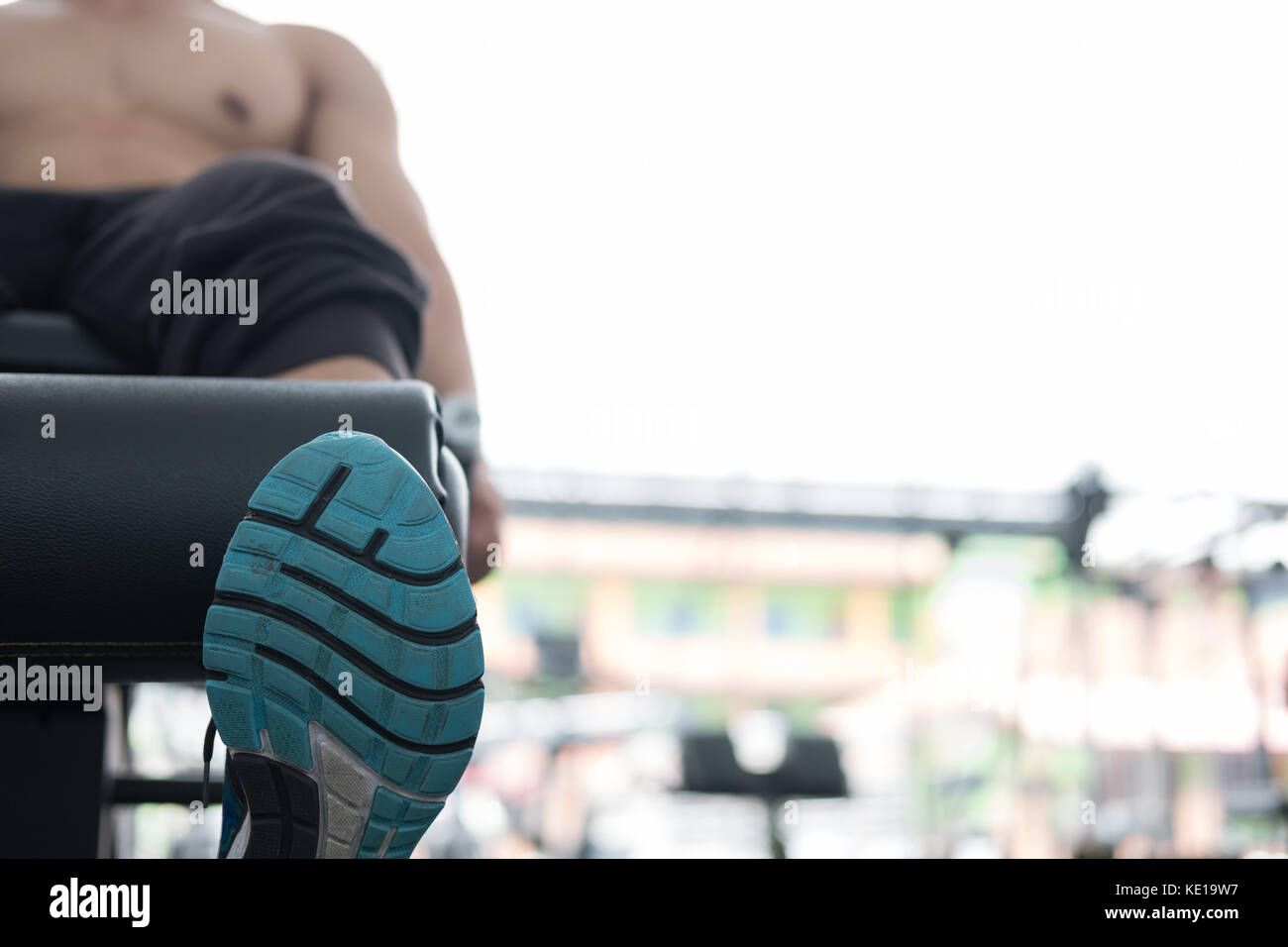 young man execute exercise with weightlifting machine in fitness center ...