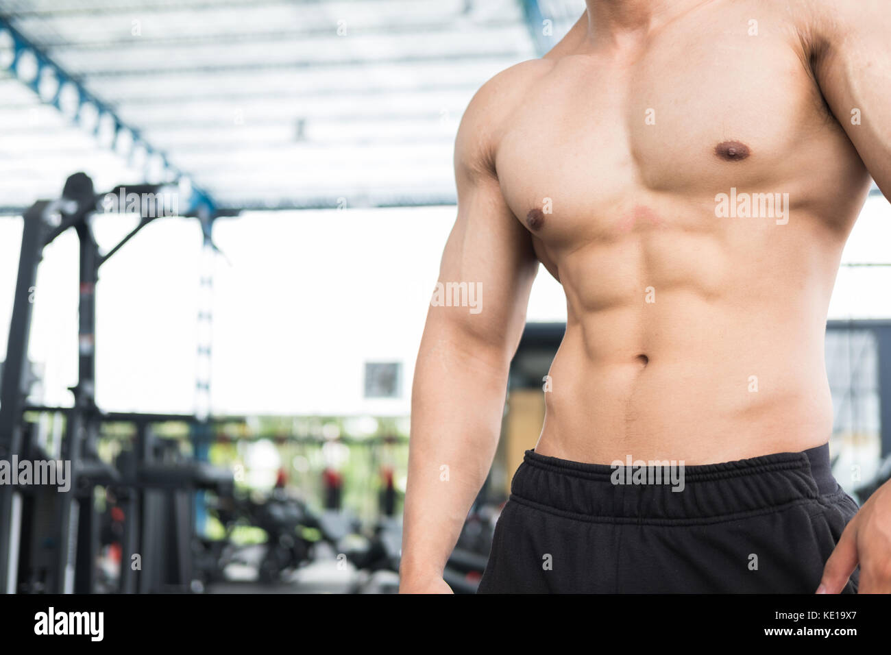 young man athlete prepare for training in gym. bodybuilder male working ...