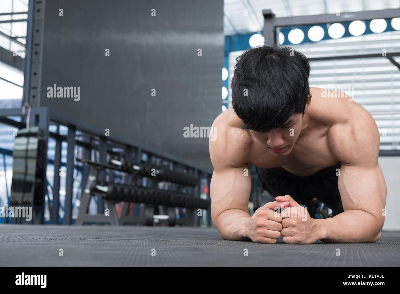 young muscle man doing plank position in gym. bodybuilder male working ...