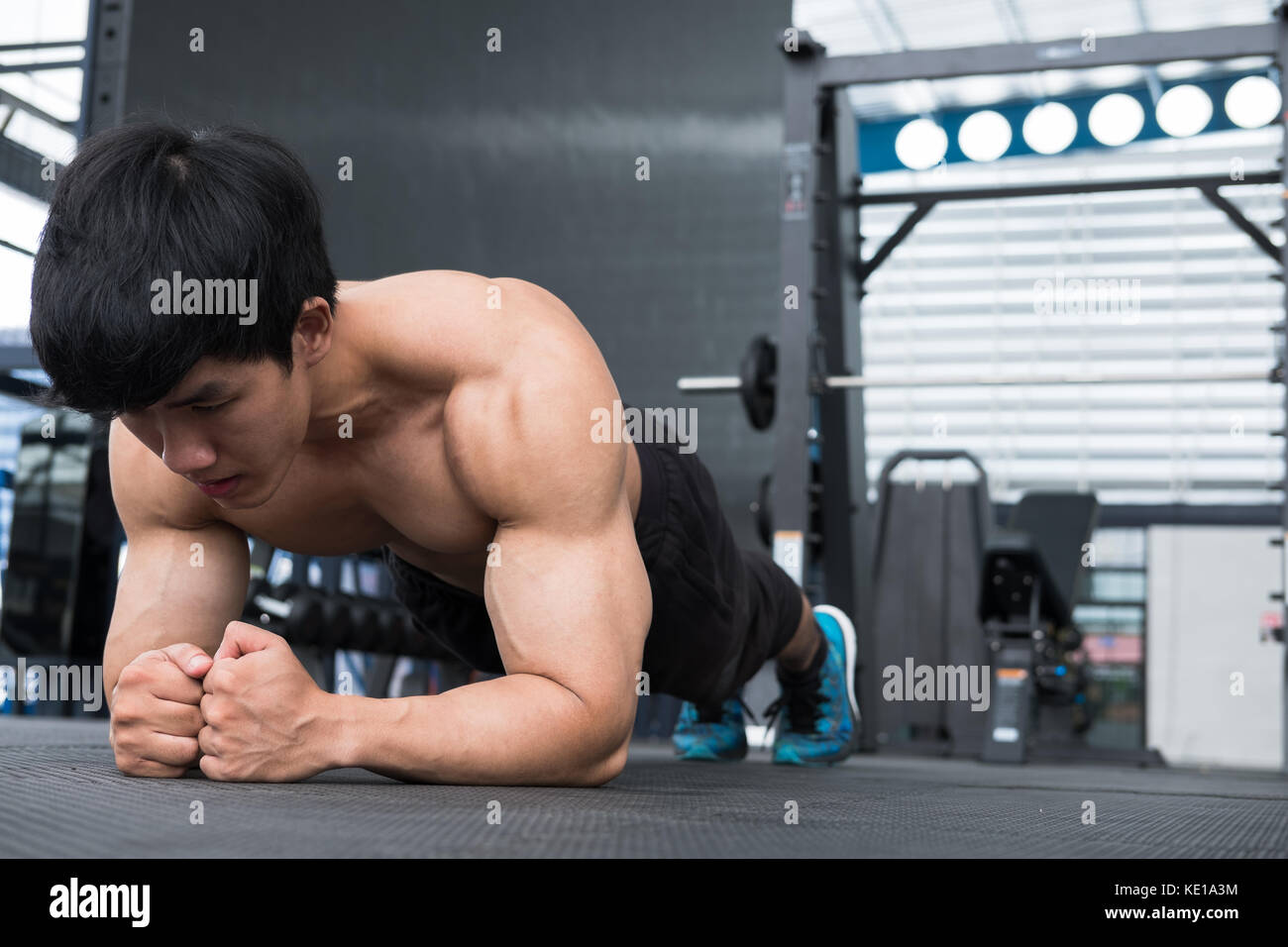 young muscle man doing plank position in gym. bodybuilder male working ...