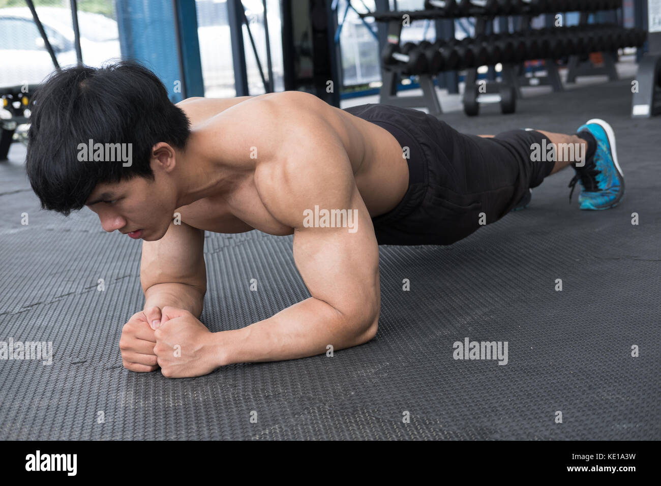 young muscle man doing plank position in gym. bodybuilder male working ...