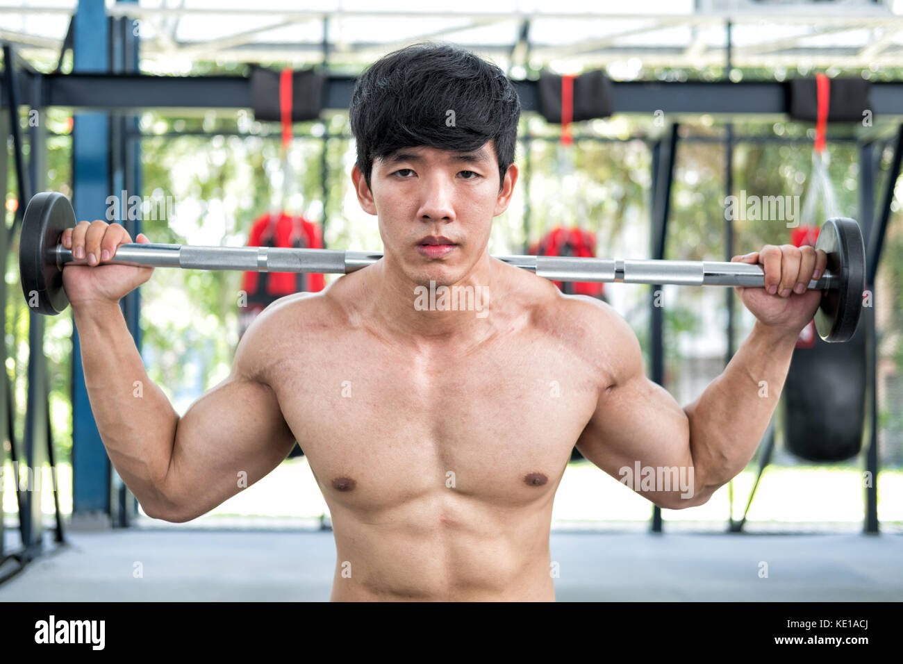 young muscular man execute exercise in fitness center. male athlete ...