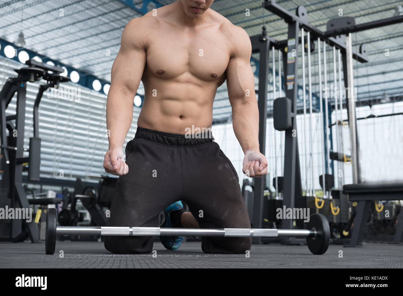 young muscular man execute exercise in fitness center. male athlete ...