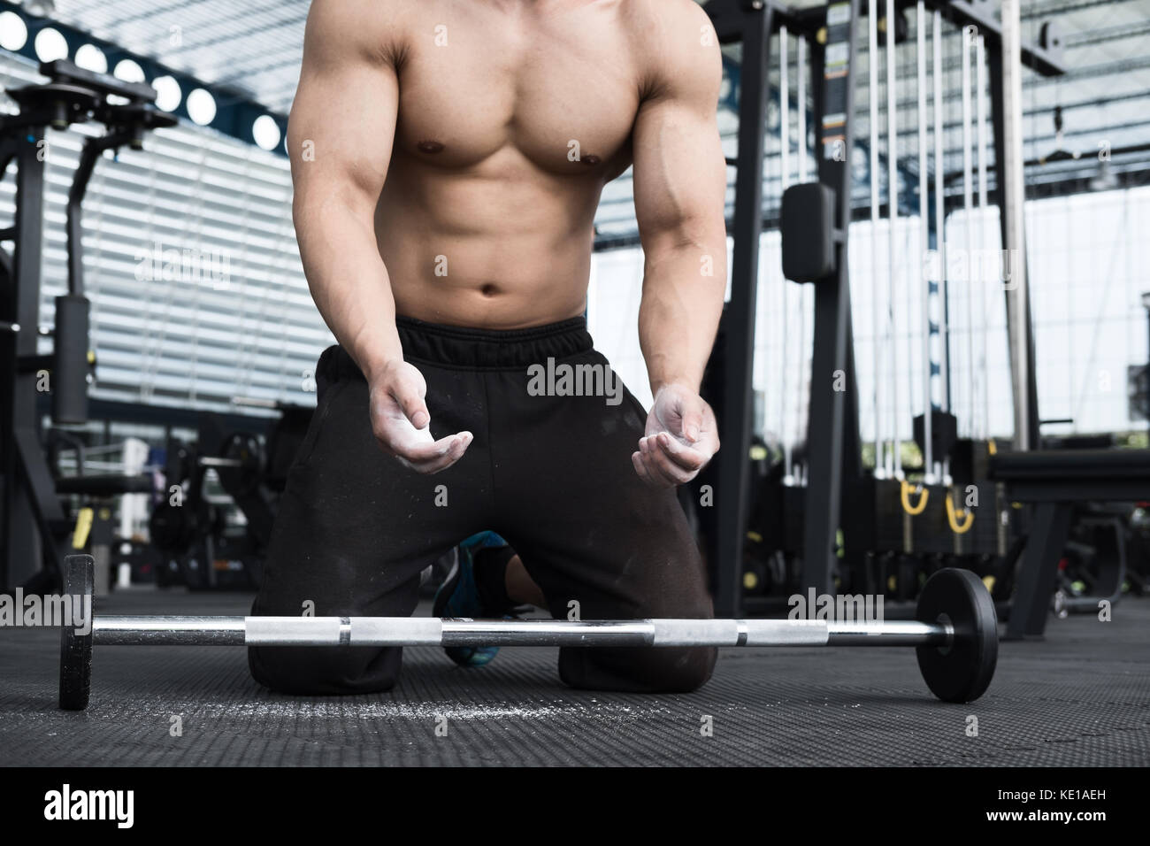 young muscular man execute exercise in fitness center. male athlete ...