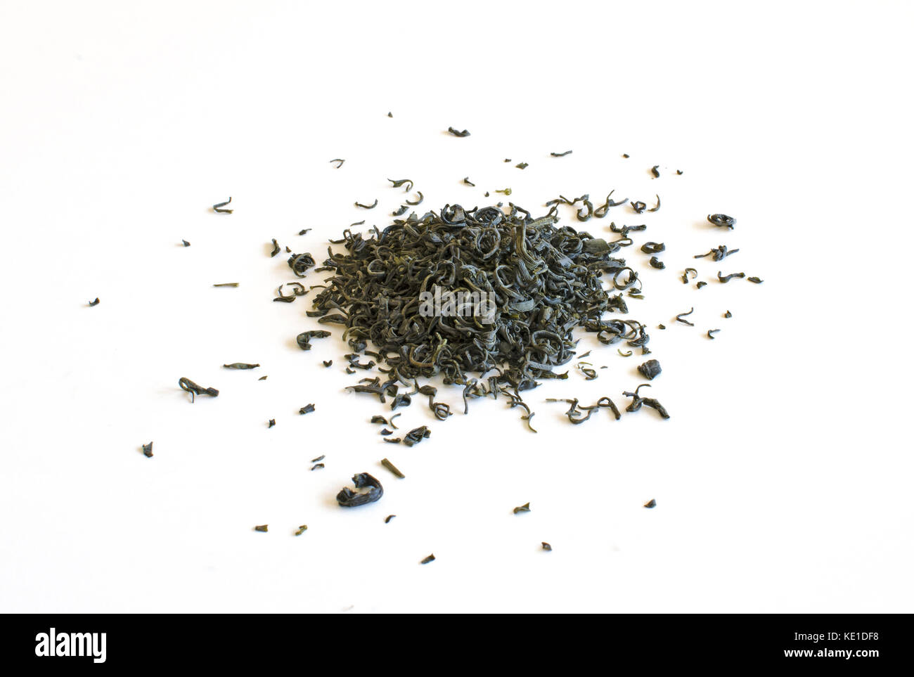 Still Life with a pile of green tea leaves scattered on a table ...