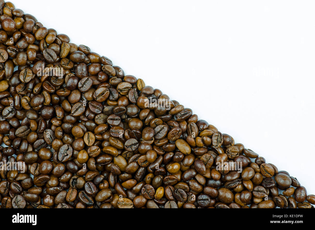 Close-up view of coffee beans surface isolated on white background with ...