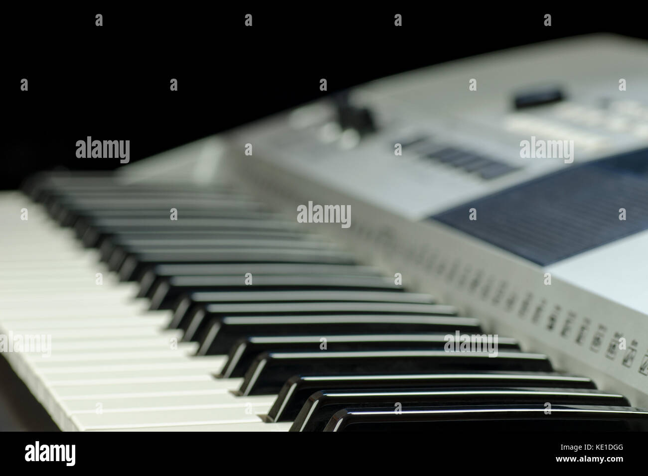 Close-up view of a music keyboard with buttons and display on a blurred ...