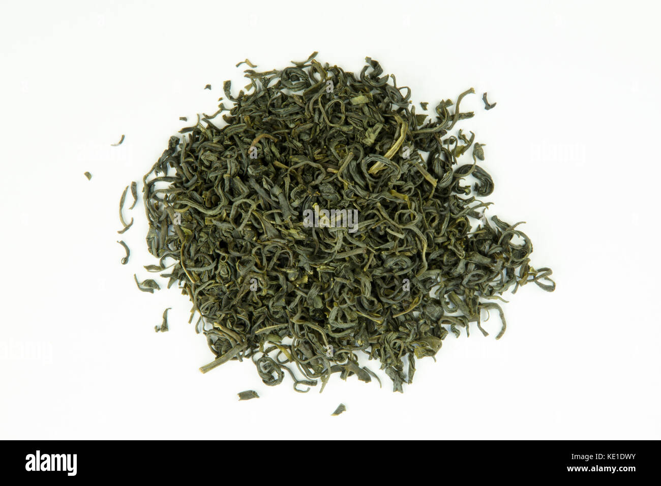 Still life with a close-up view of green tea leaves isolated on a white ...
