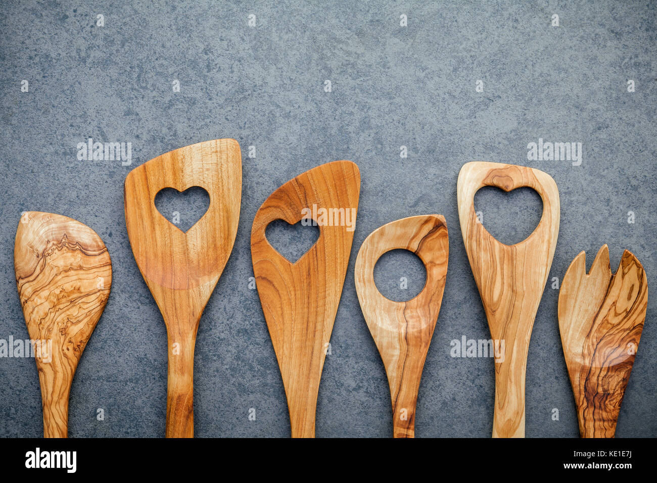 Various wooden cooking utensils border. Wooden spoons and wooden ...