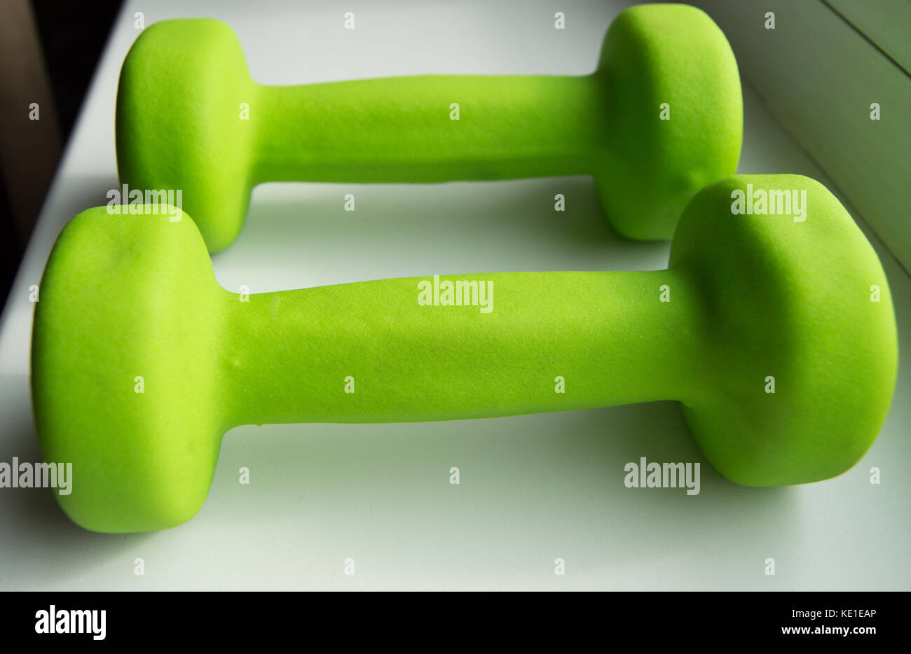 the concept of fitness, a healthy lifestyle - two green dumbbells for ...