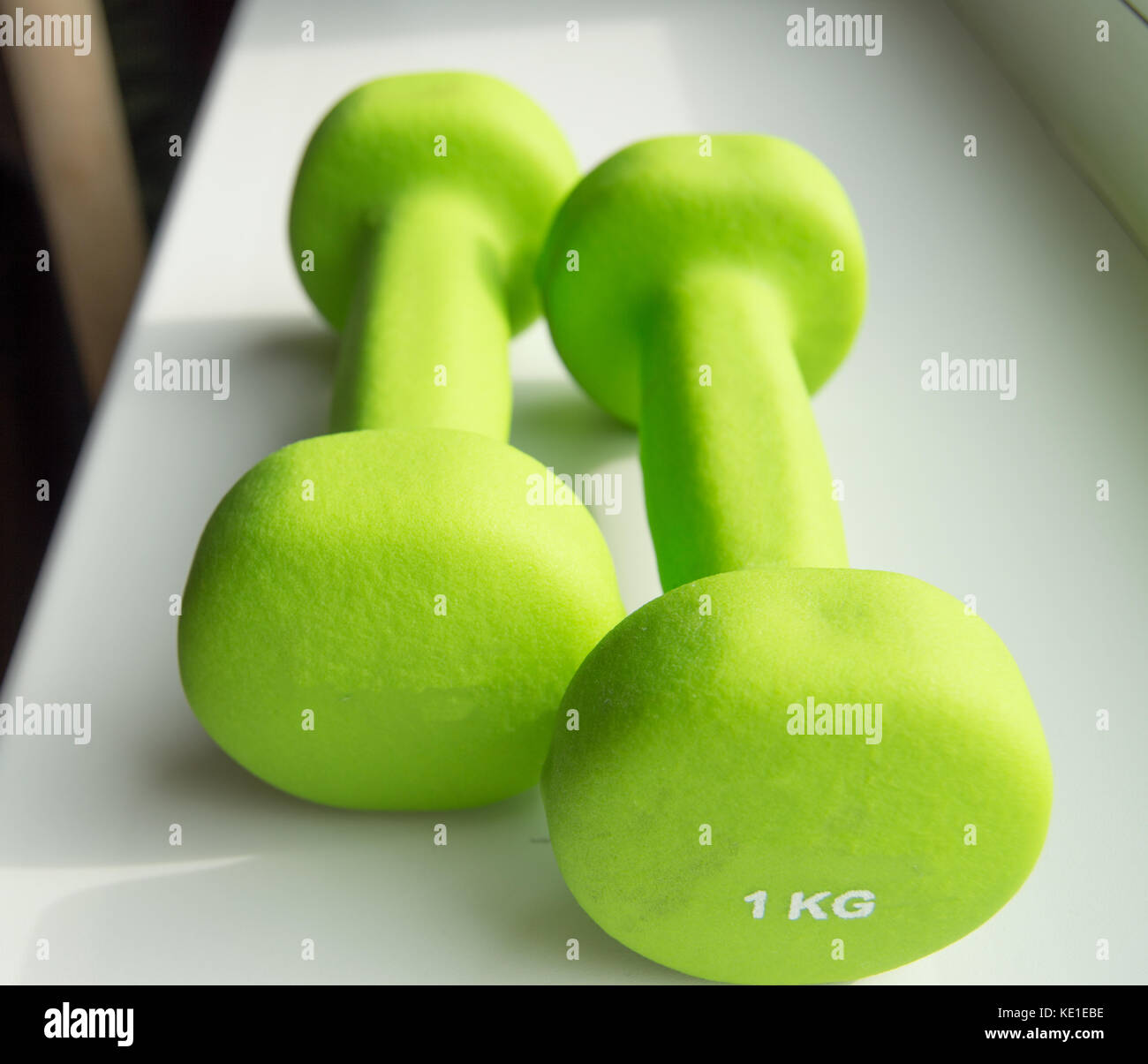 the concept of fitness, a healthy lifestyle - two green dumbbells for ...