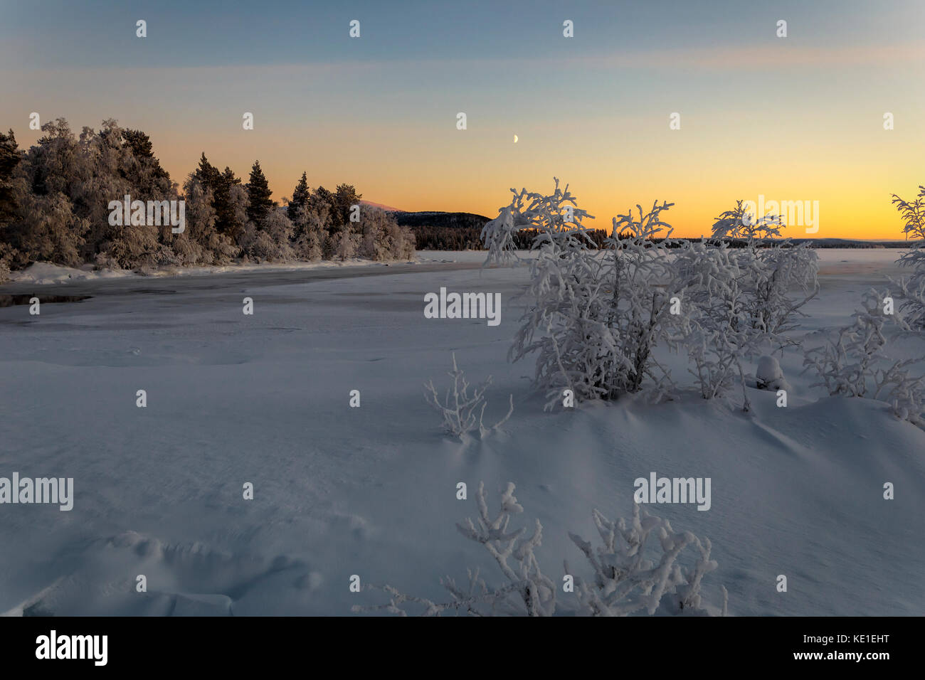 Winter lake in Finland at sunset Stock Photo - Alamy