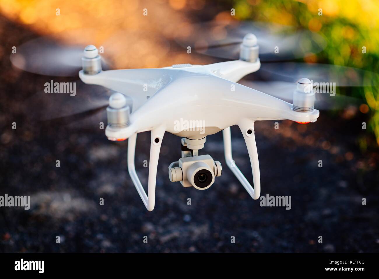 White drone quadcopter with camera in flight Stock Photo - Alamy