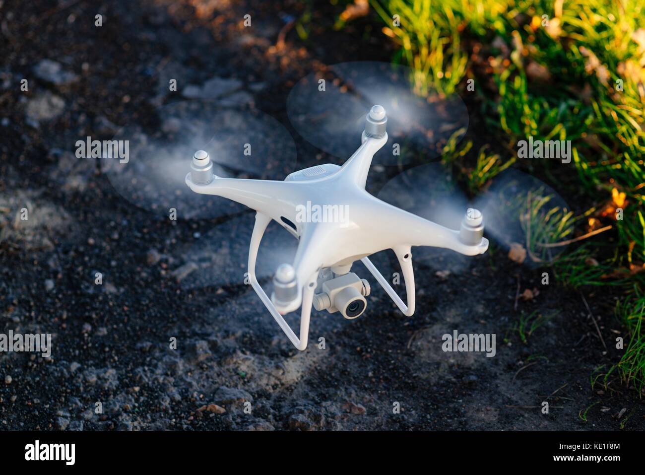 White drone quadcopter with camera in flight Stock Photo - Alamy