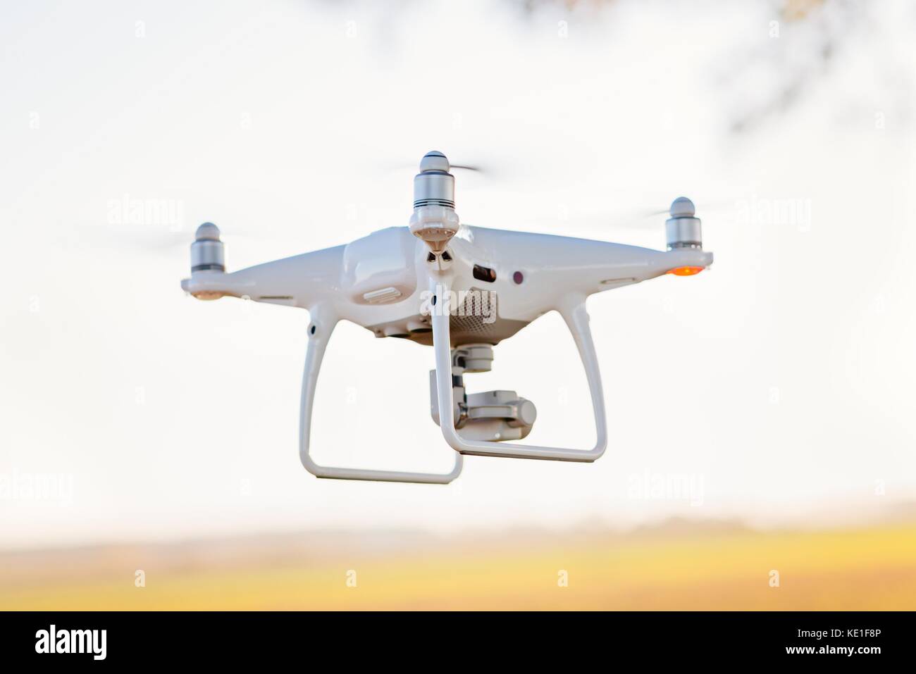 White drone quadcopter with camera in flight Stock Photo - Alamy