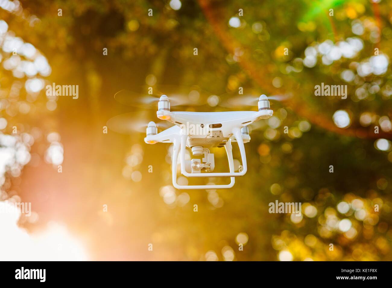 White drone quadcopter with camera in flight Stock Photo - Alamy