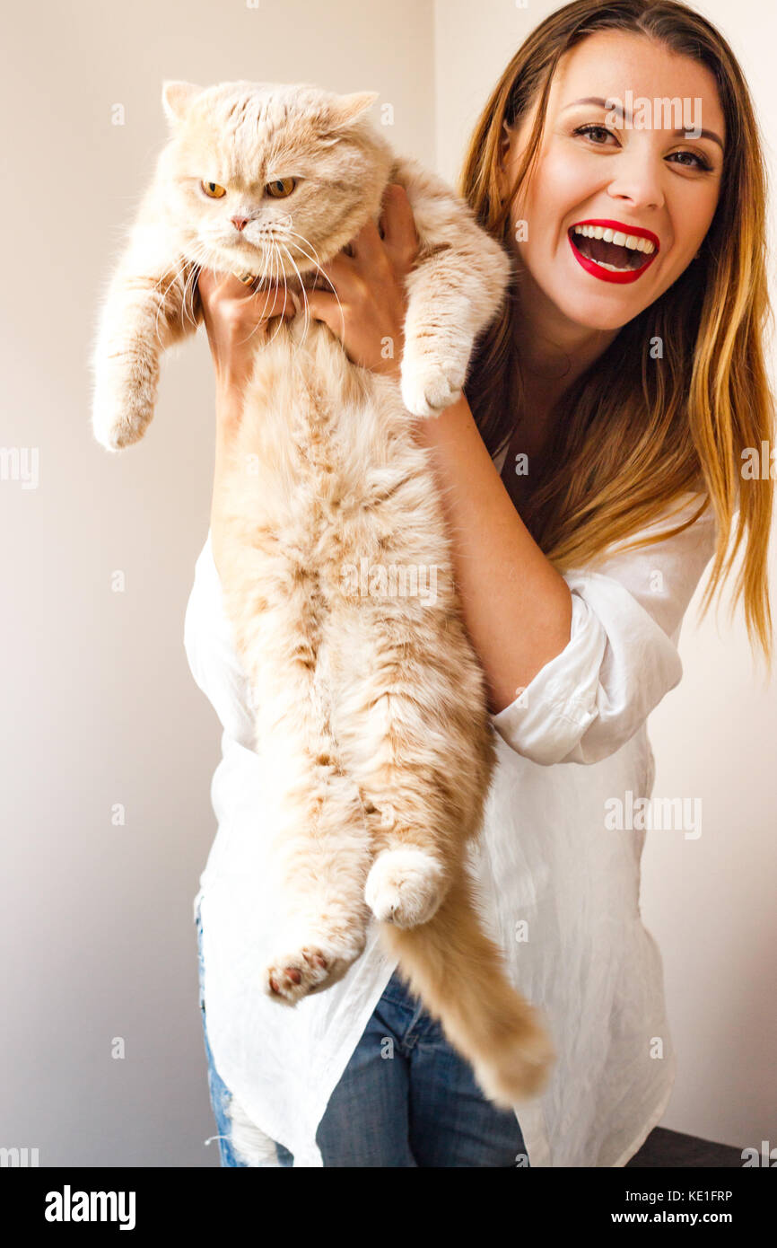 Beautiful girl with a red cat Stock Photo - Alamy