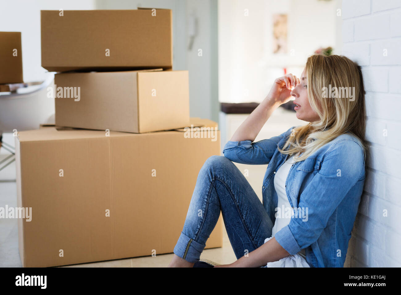 Tired woman exhausted while moving into new home Stock Photo - Alamy