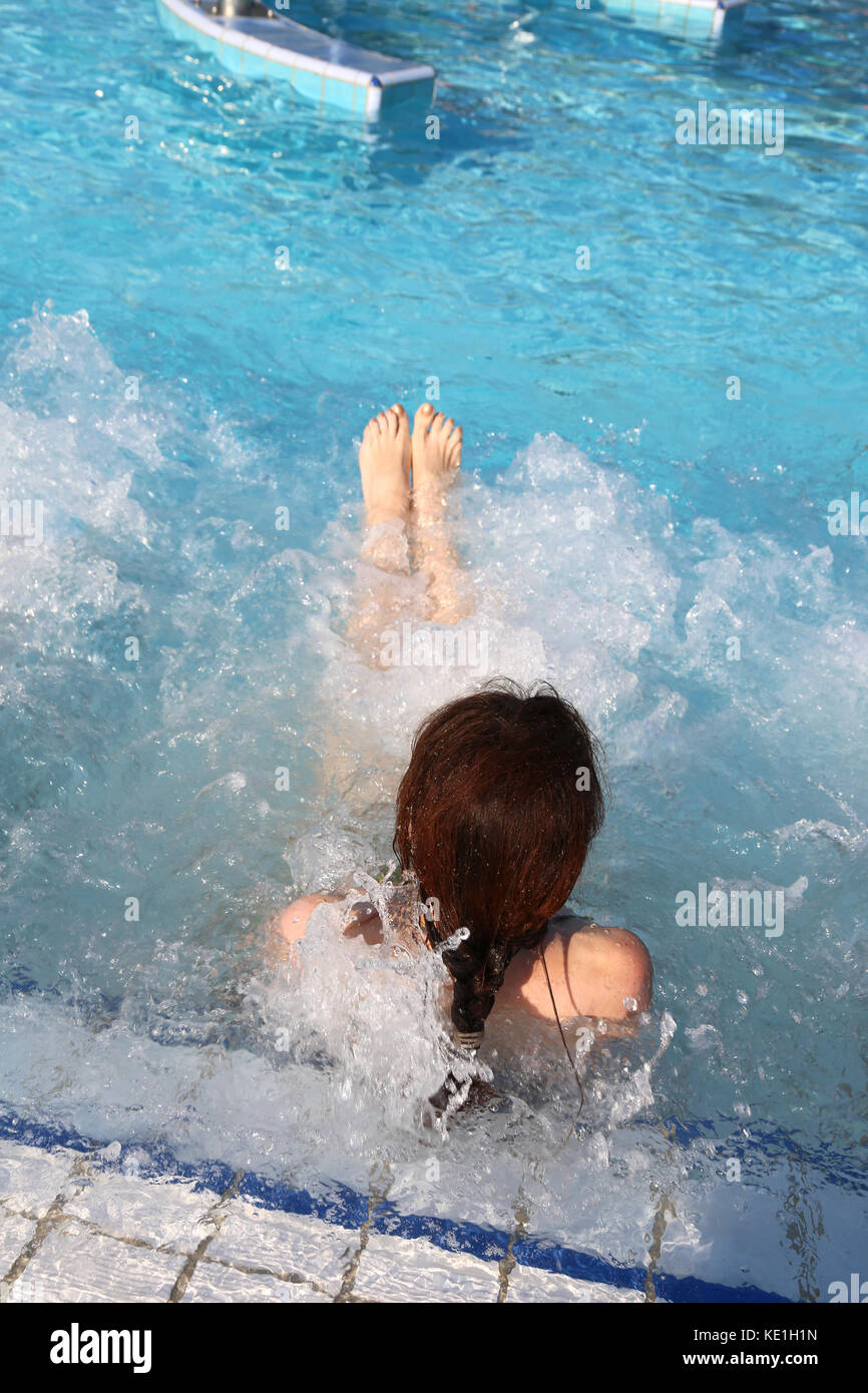 woman during hydromassage sitting in the pool Stock Photo - Alamy