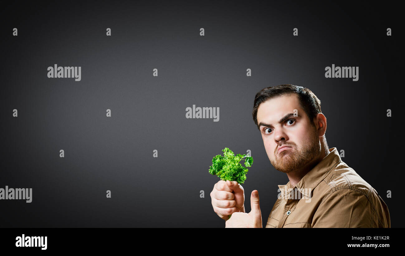 Man holding parsley and raises his thumb up Stock Photo - Alamy