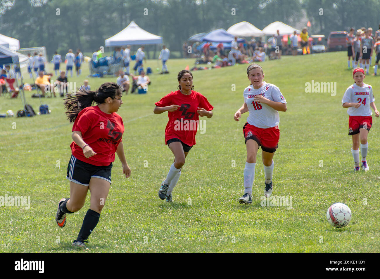 American high school teenage girls playing soccer in a game tournament ...