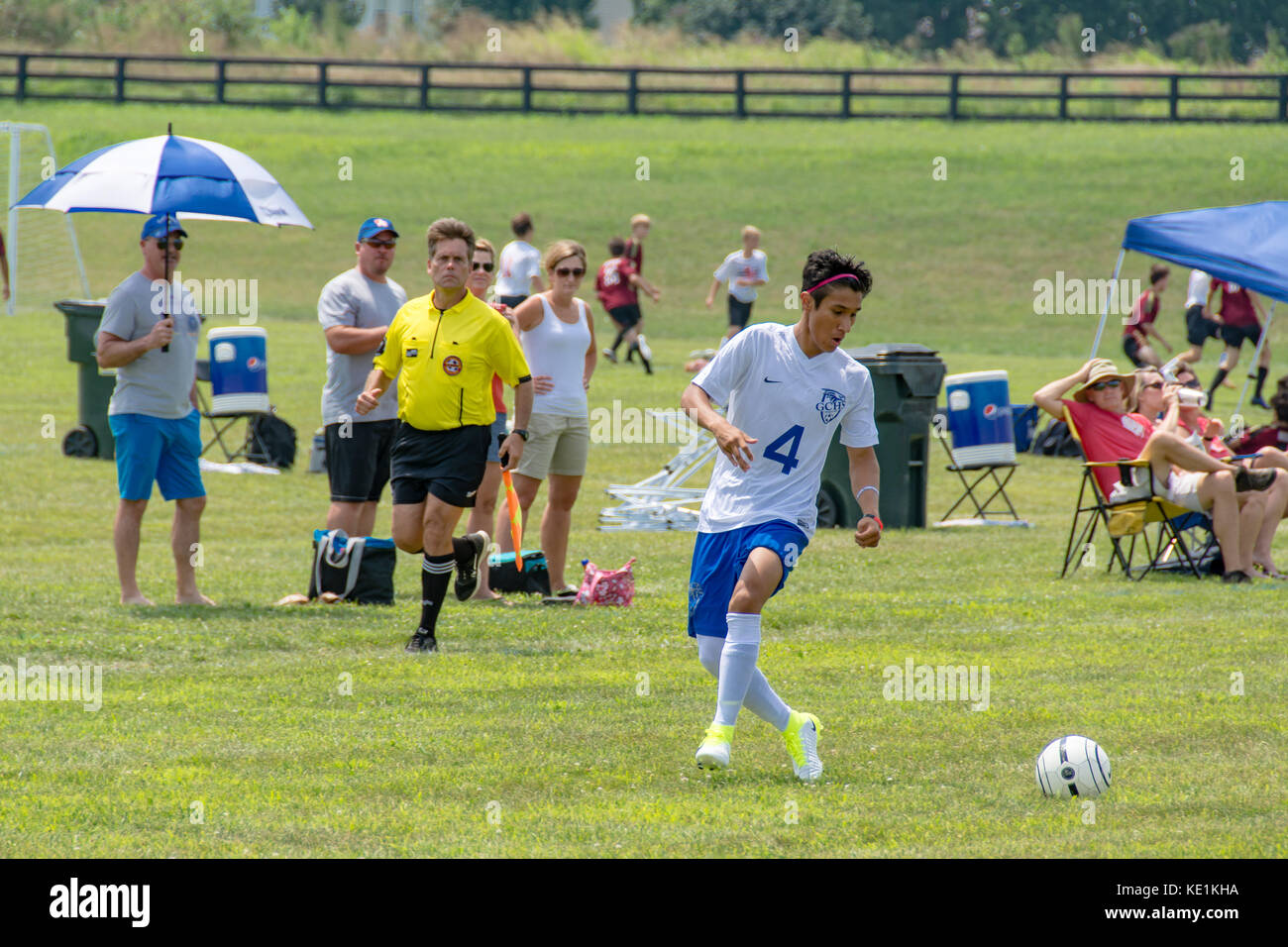 American high school teenage boys playing soccer in a game tournament ...