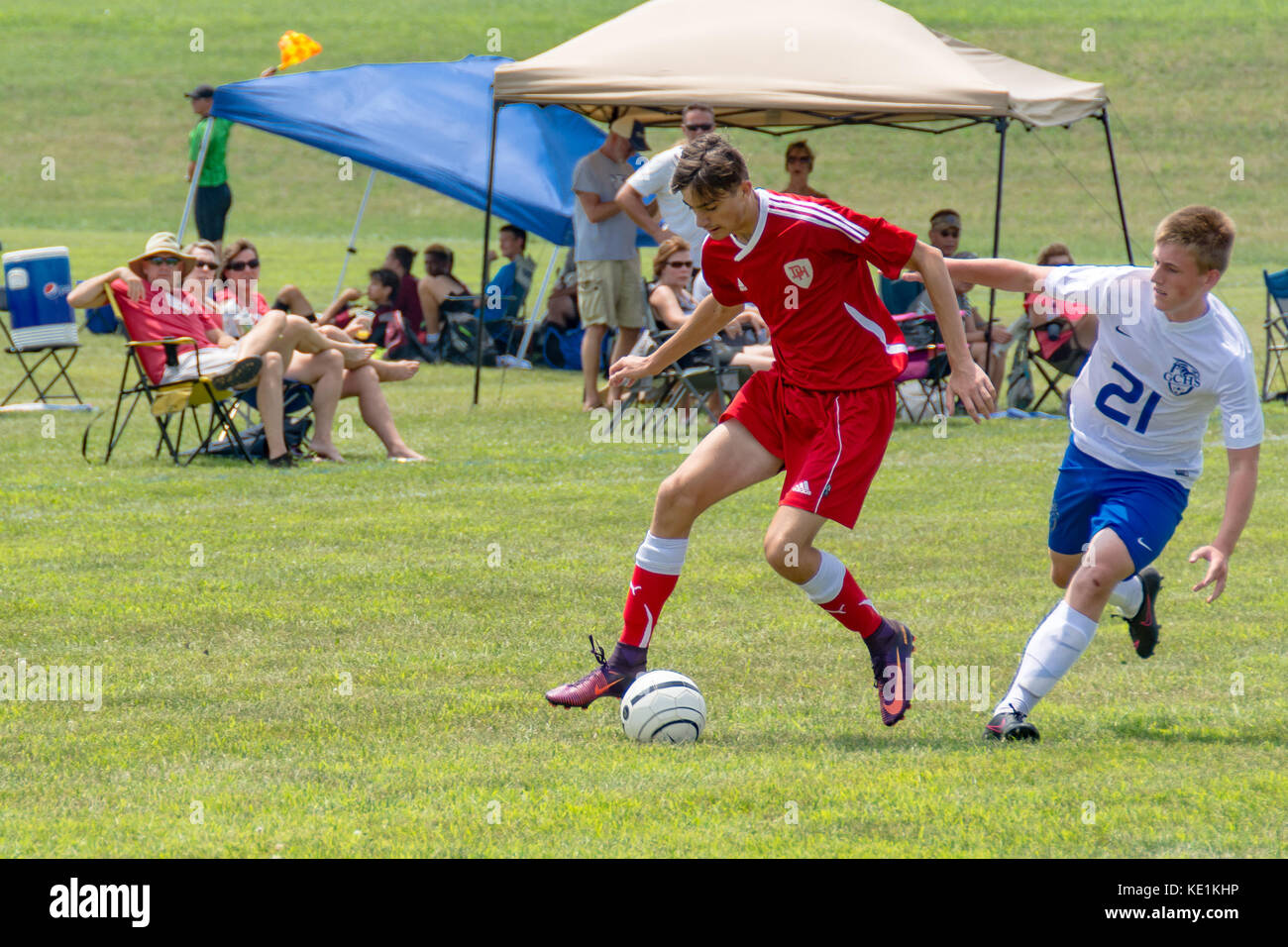 American high school teenage boys playing soccer in a game tournament ...