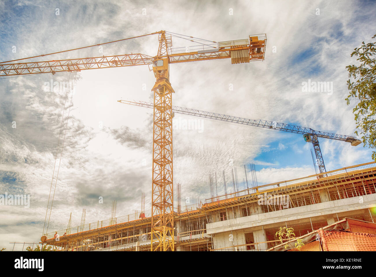 Construction crane on construction site over cloudy blue sky. Support ...