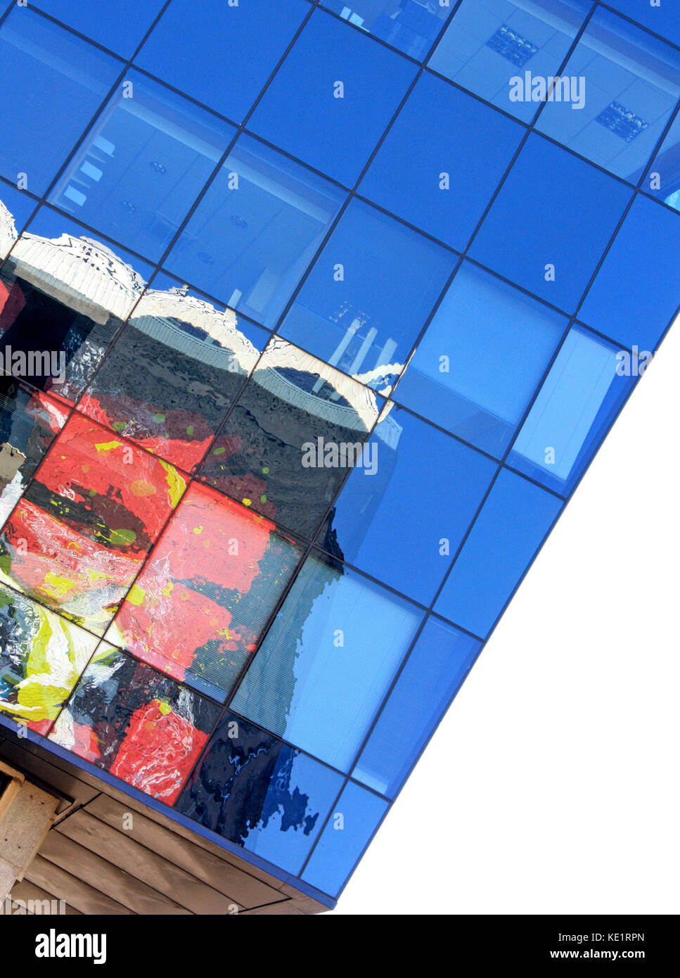 reflection of building in glass building across the road. Blue glass ...