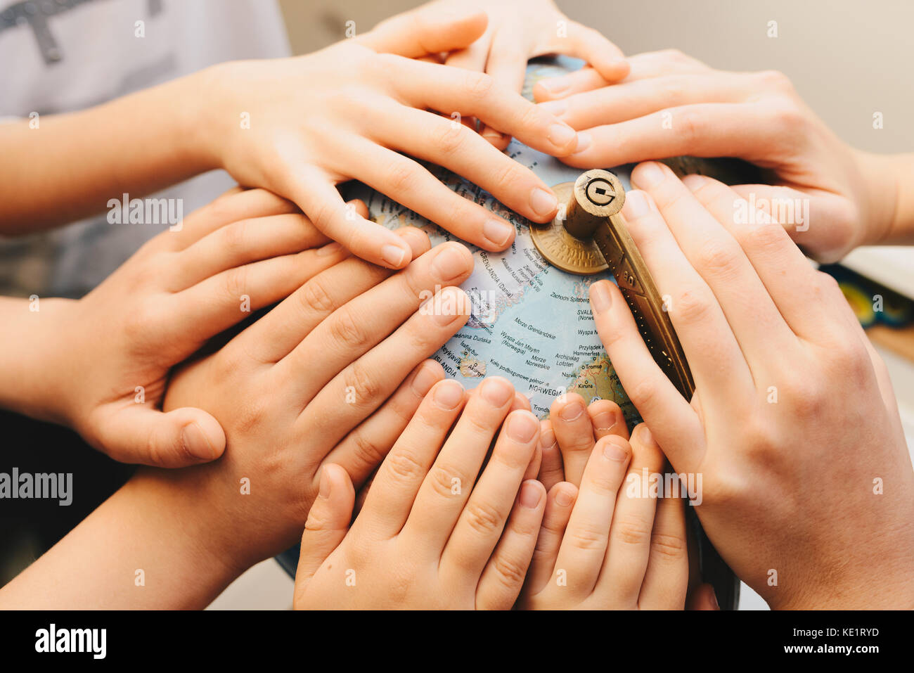 Kids hands together on globe - diversity education concept Stock Photo ...