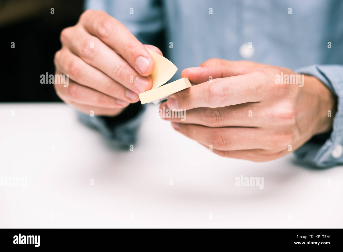 cropped view of male hands holding sticky notes Stock Photo - Alamy