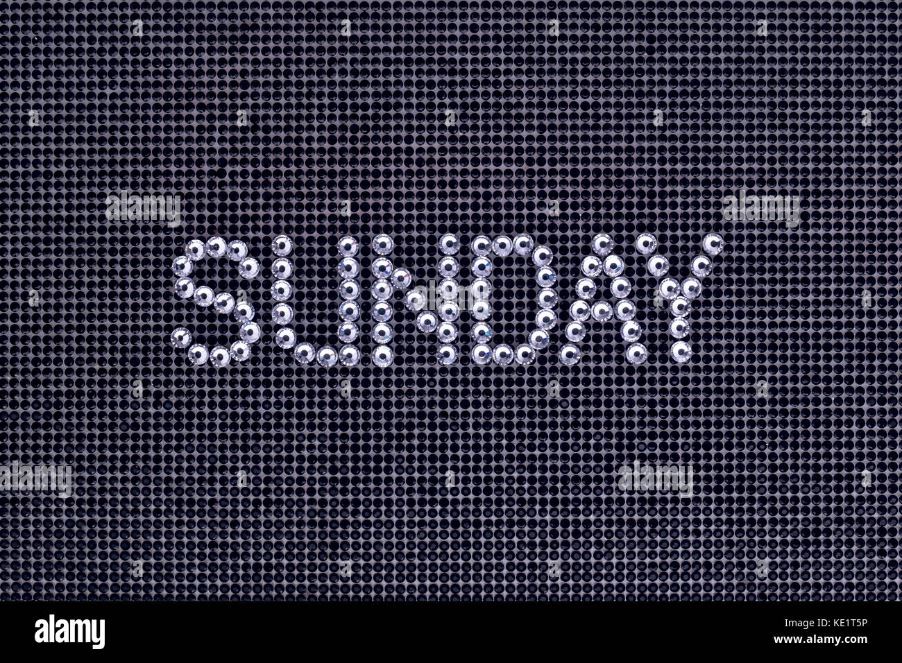 Day of the week, word SUNDAY is made rhinestones crystal color on a ...