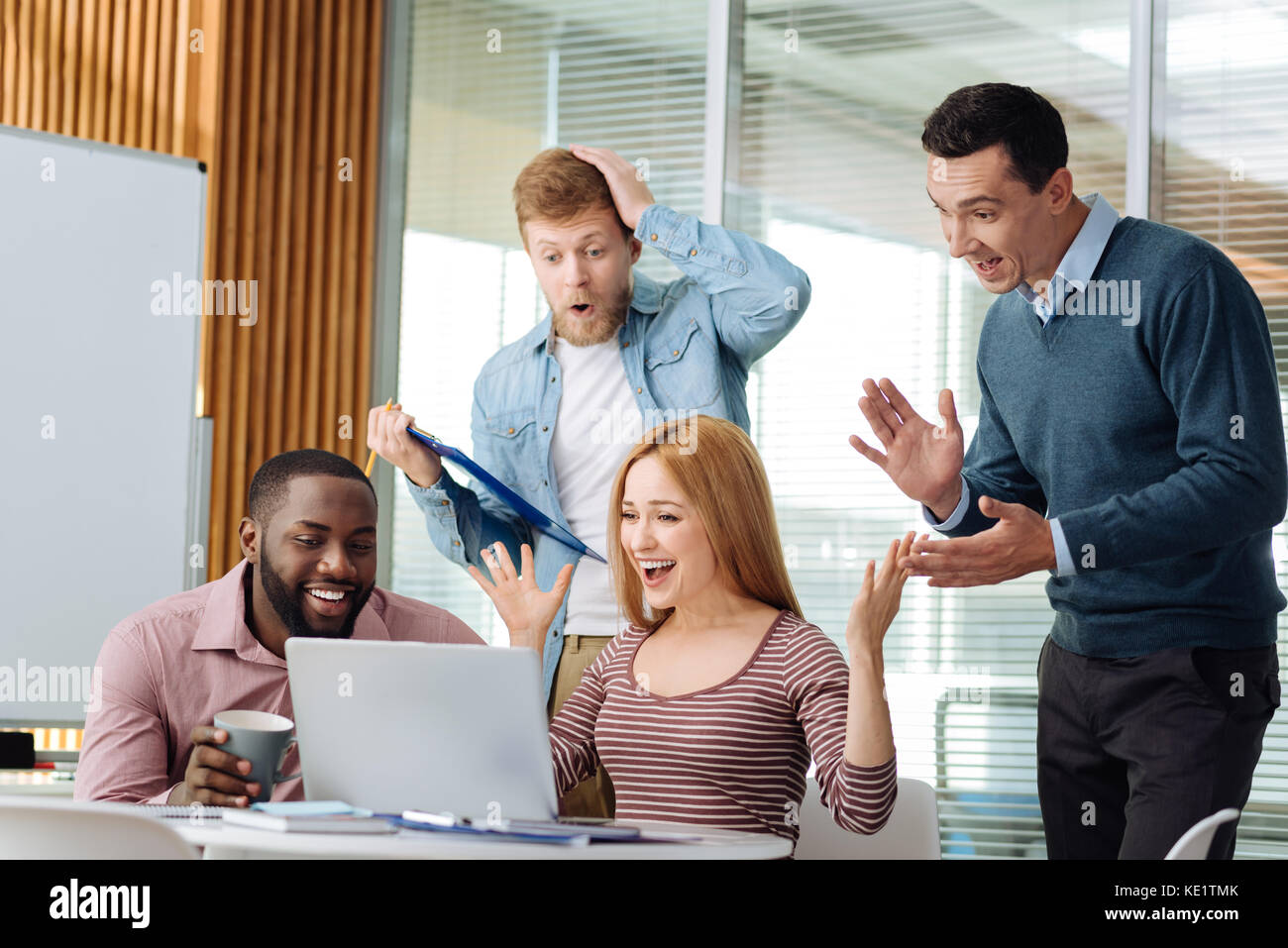 Happy woman raising both arms Stock Photo - Alamy
