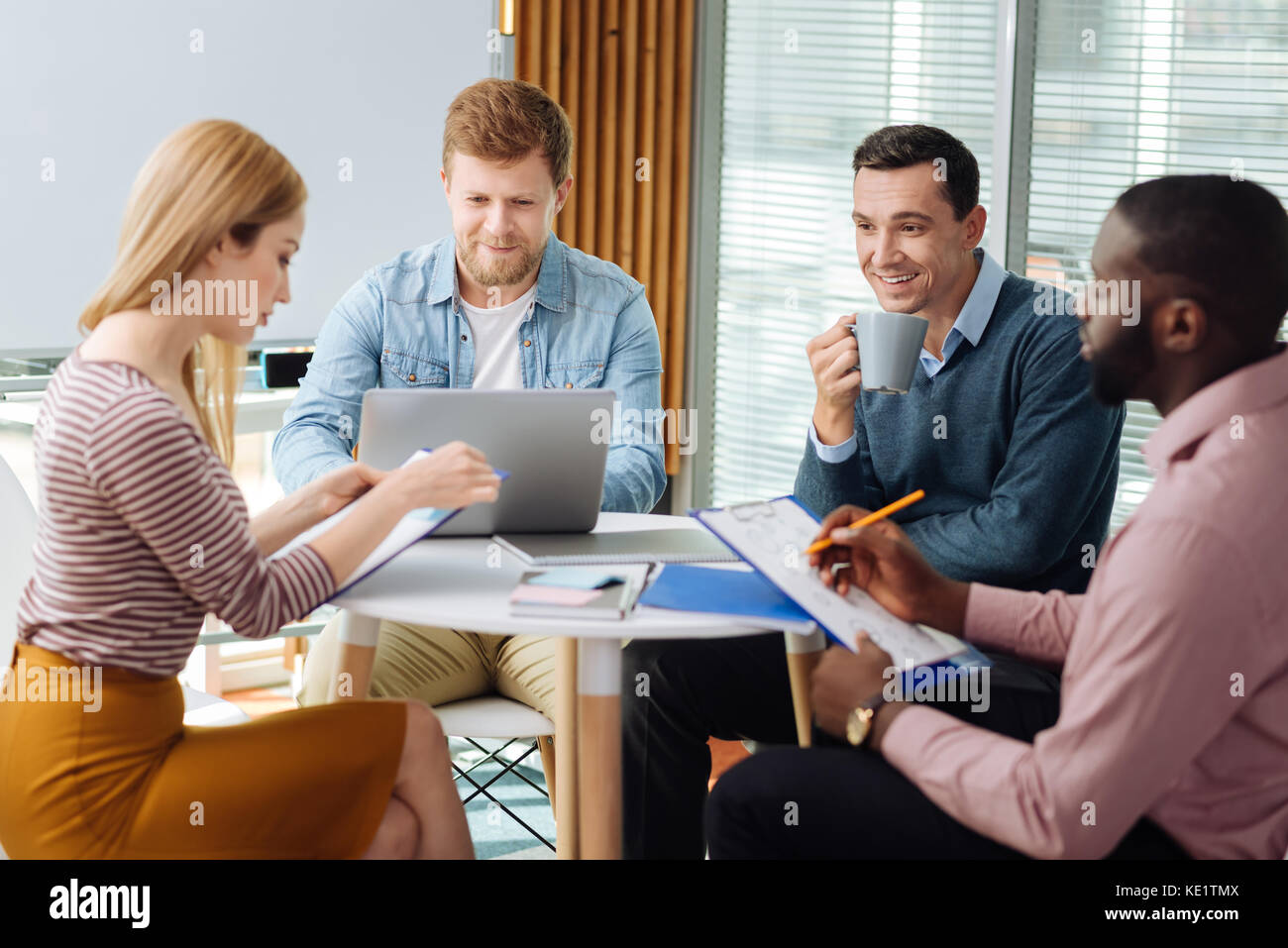 Concentrated woman checking her colleagues Stock Photo - Alamy