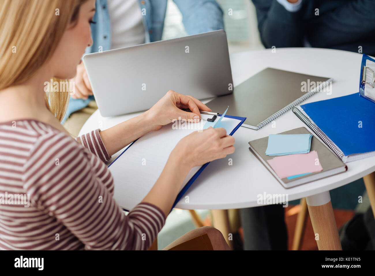 Attentive female person working in team Stock Photo - Alamy