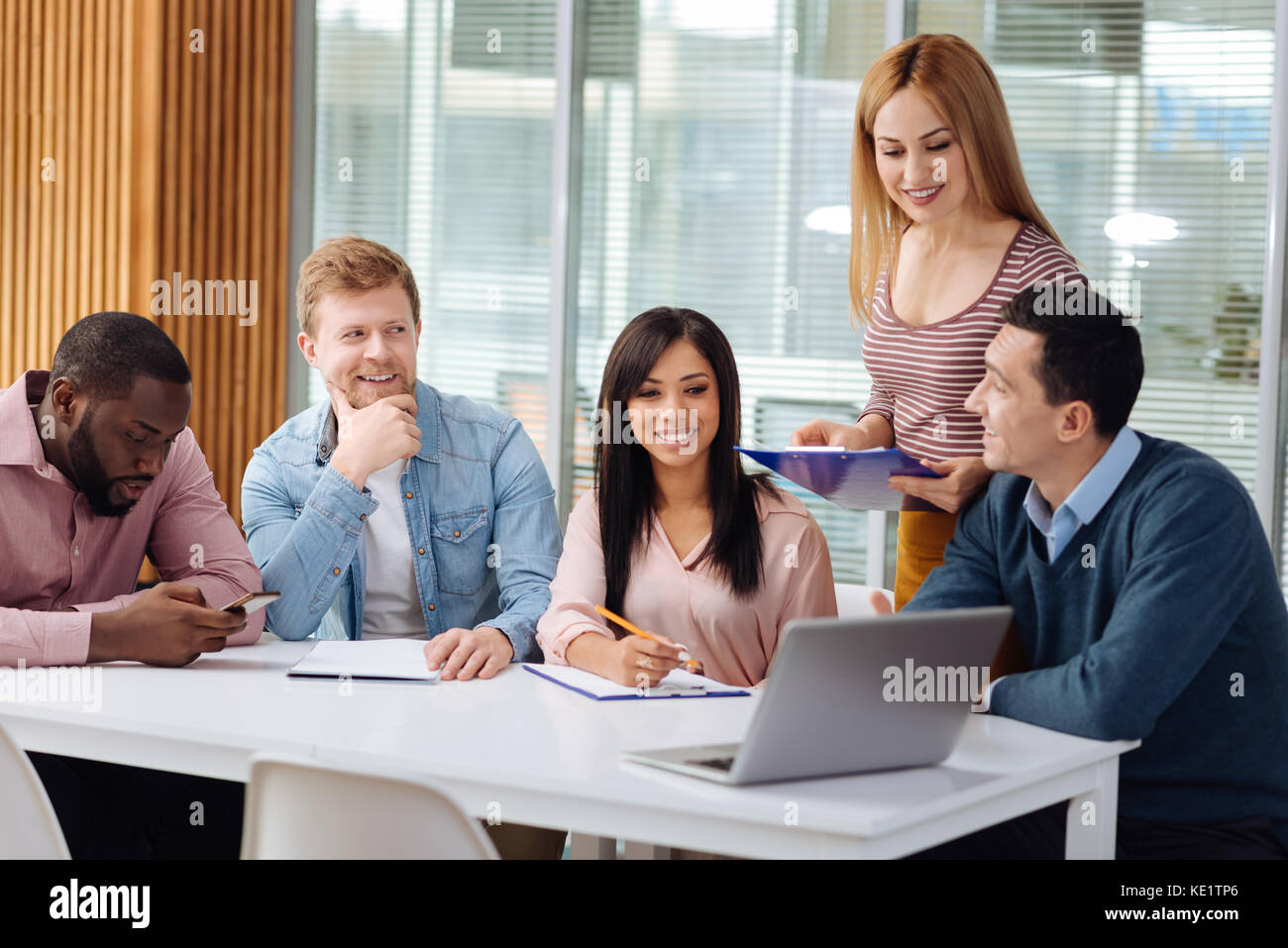 Positive colleagues sitting in conference hall Stock Photo - Alamy