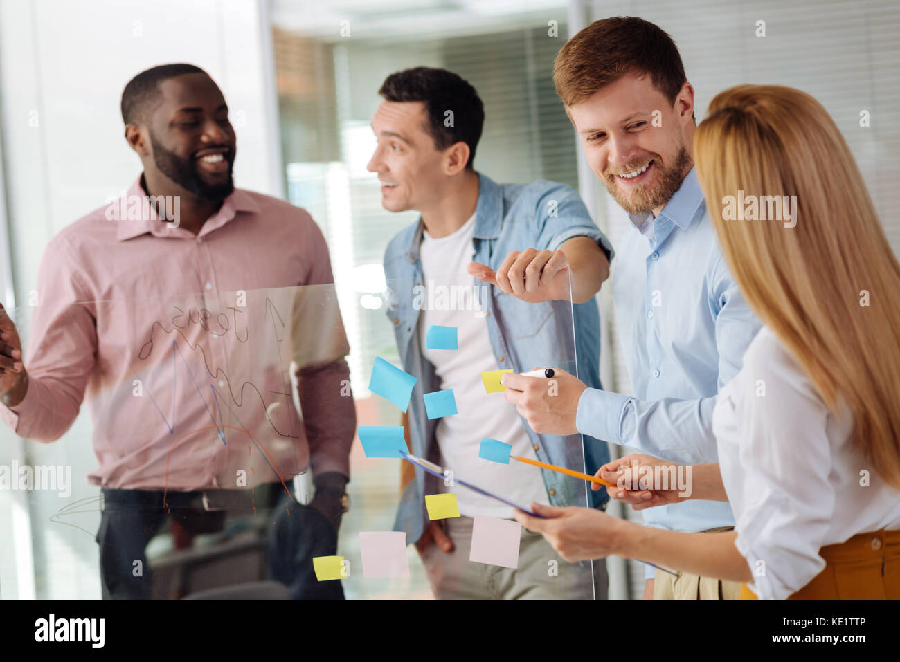 Smiling bearded man explaining scheme Stock Photo - Alamy