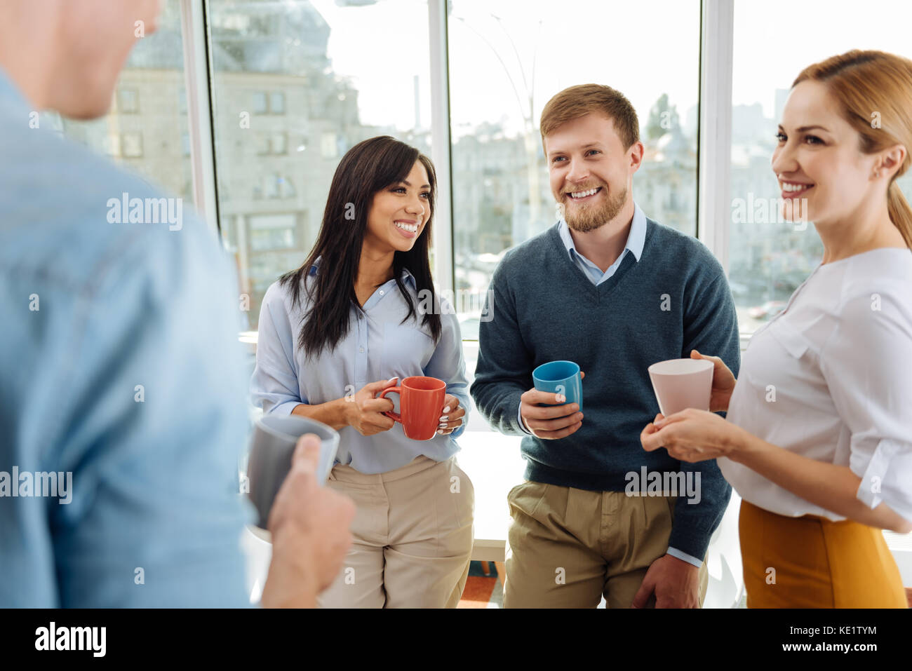 Relaxed colleagues having tea break Stock Photo - Alamy