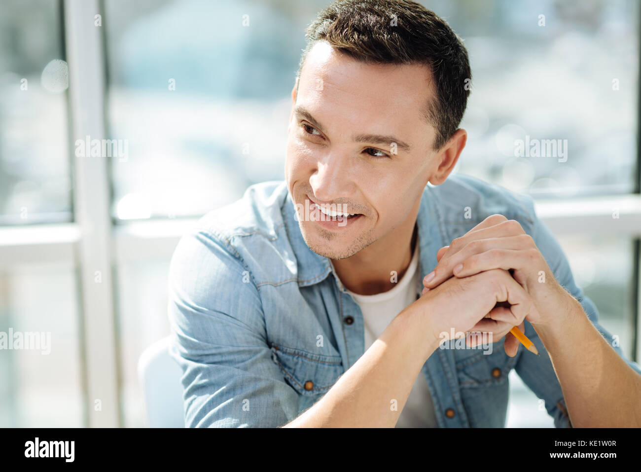 Positive delighted man turning head Stock Photo - Alamy