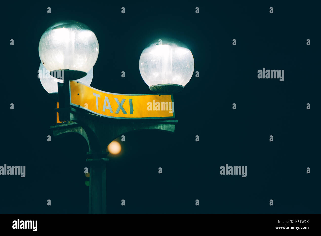 Taxi stand sign on the post at nighttime Stock Photo - Alamy