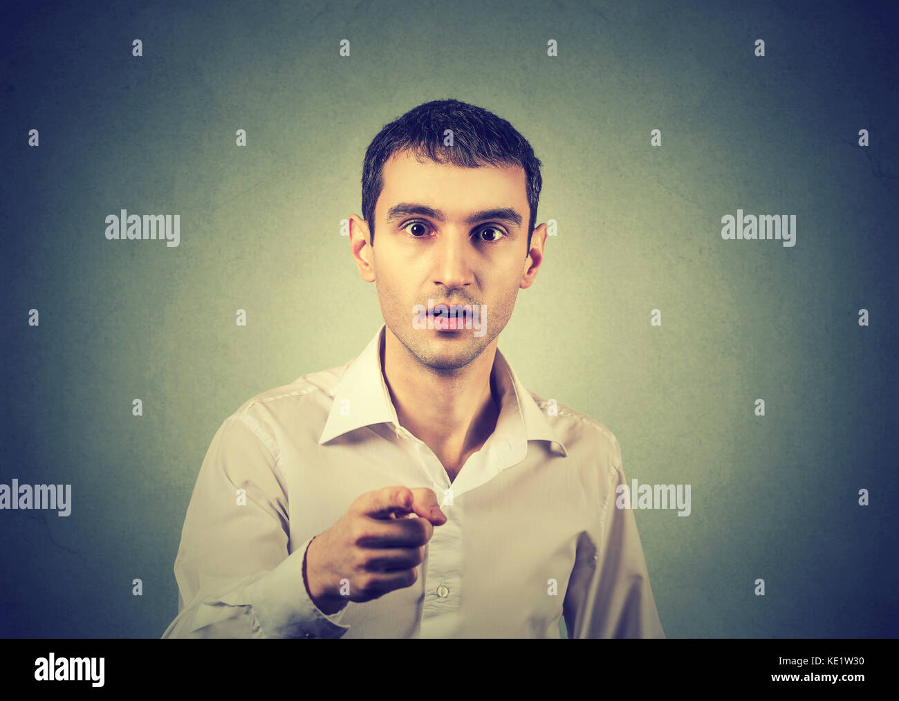 Surprised stunned man pointing finger at you camera Stock Photo - Alamy